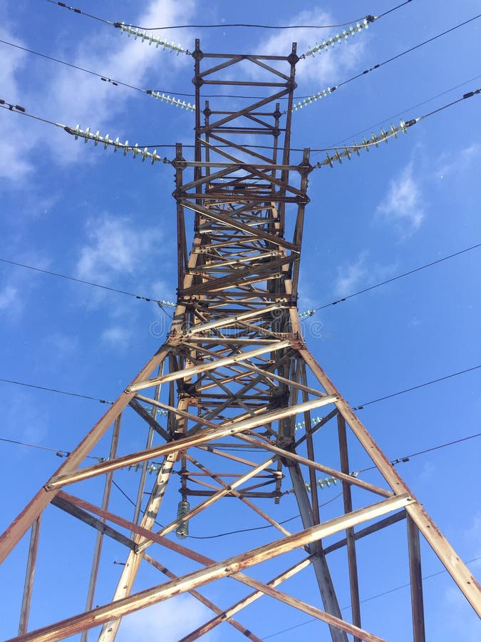 Power Line Against a Blue Sky. High Voltage Tower. Bottom-up View ...
