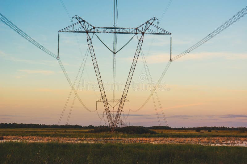 Power Line in a Field on the Background of Beautiful Sunset Stock Photo ...