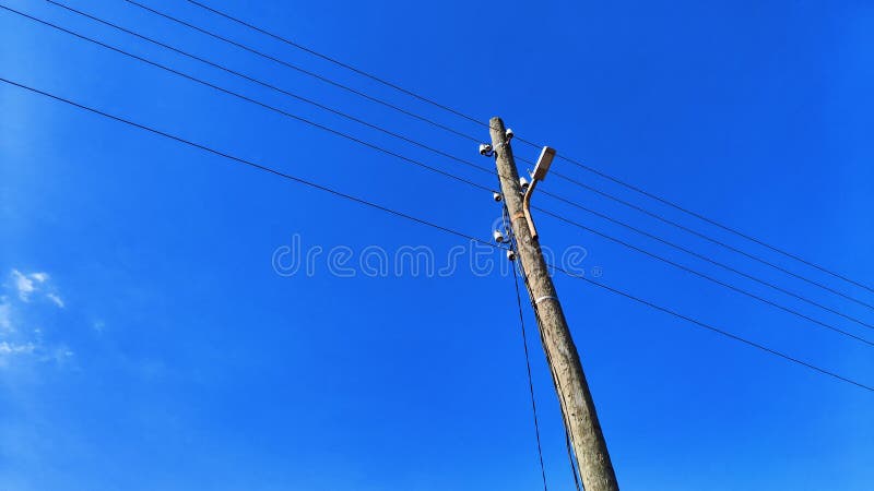 Power Line Pole on a Blue Sky Background Stock Photo - Image of utility ...