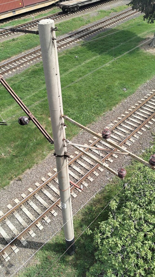 A Power Line Pole with Wires, Grass and Bushes and Railway Tracks Stock ...