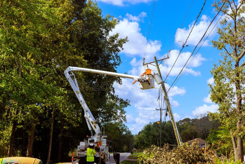 Power Line Worker Repairs Installs Equipment on Utility Pole Using a ...