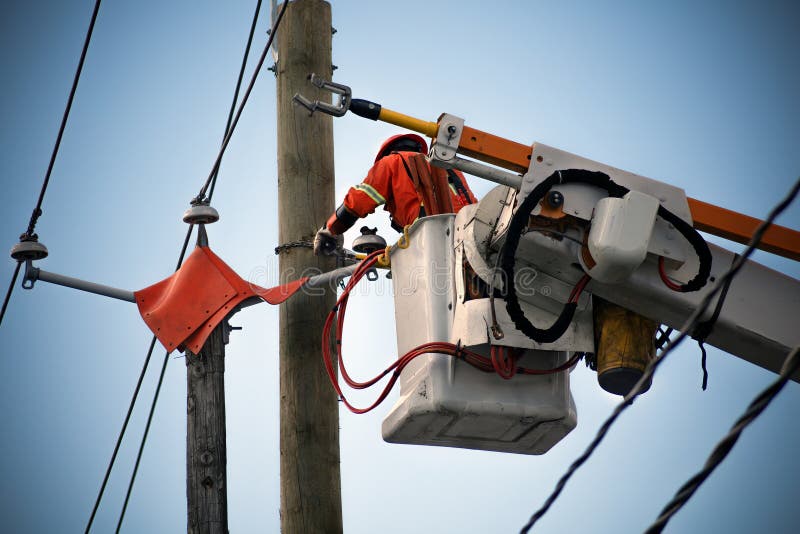 Electricity Line Worker Repairing Power Lines Using Aerial Platform ...
