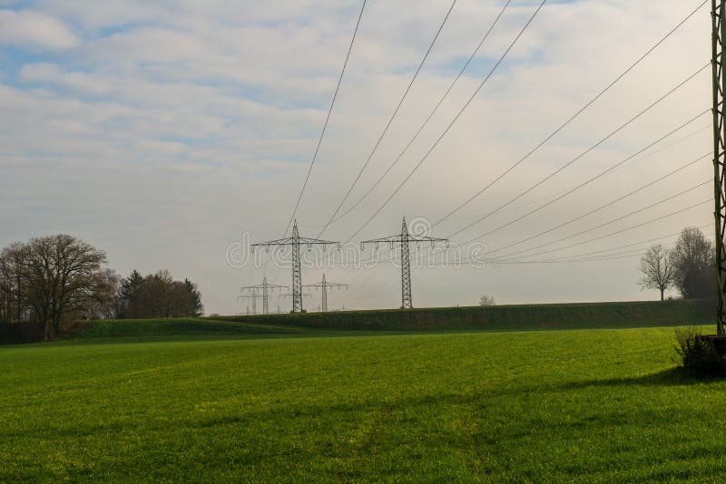 Power lines across fields stock image. Image of industrial - 263511475