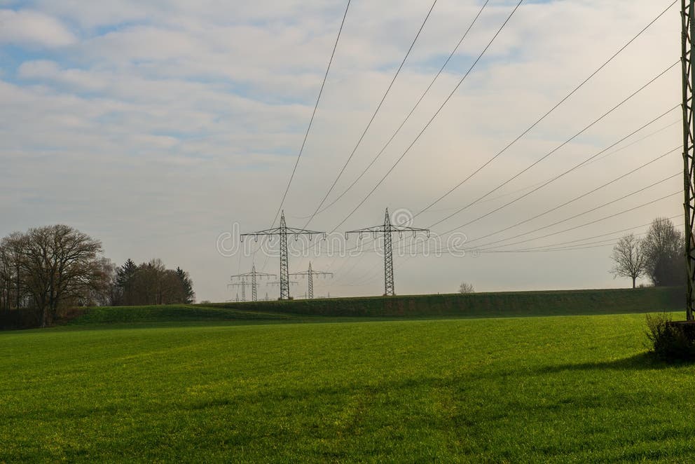 Power lines across fields stock image. Image of industrial - 263511475