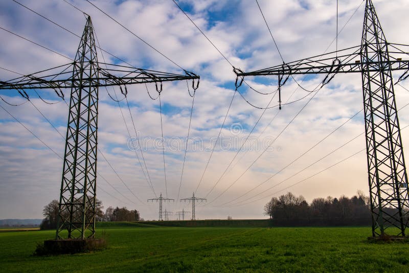 Power lines across fields stock photo. Image of industrial - 263511484
