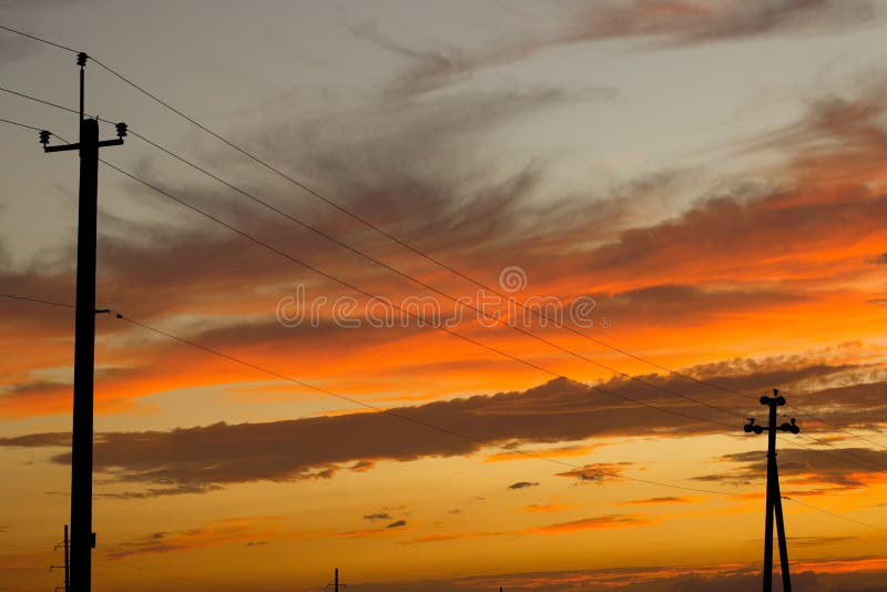 Power Lines Against a Beautiful Bright Orange Sky in the Evening Stock ...