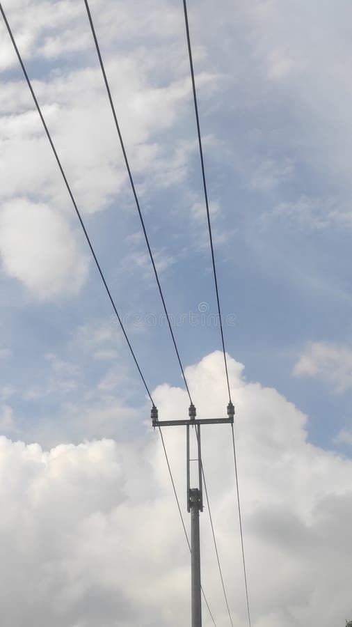 Power Lines in Blue and Cloudy Sky. High Voltage Power Lines and Cables ...