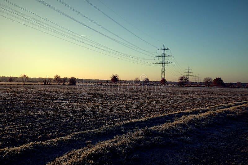 Power lines in the field stock photo. Image of environment - 184067818