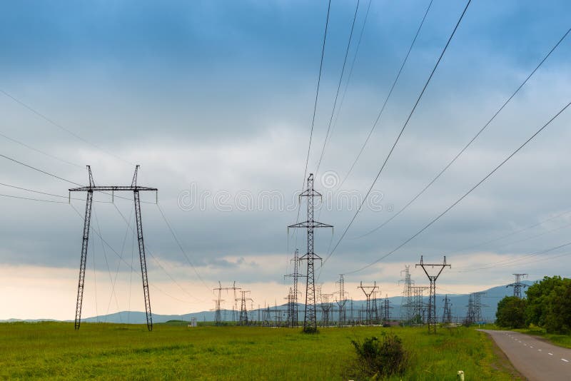 Power Lines in a Green Field Stock Photo - Image of blue, electrical ...
