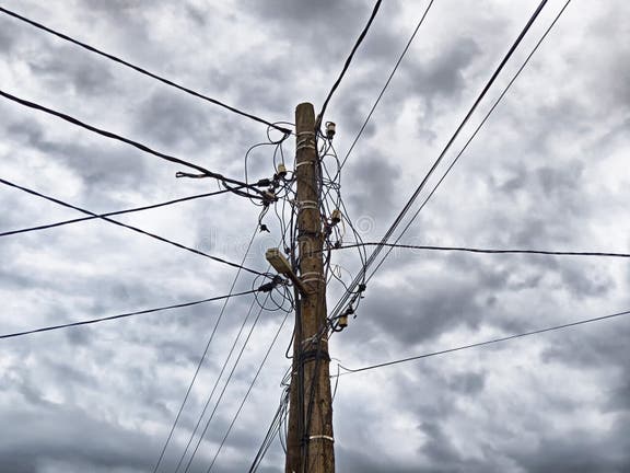 Power Lines Span Out Across a Vast, Cloudy Sky, Creating a Visual ...
