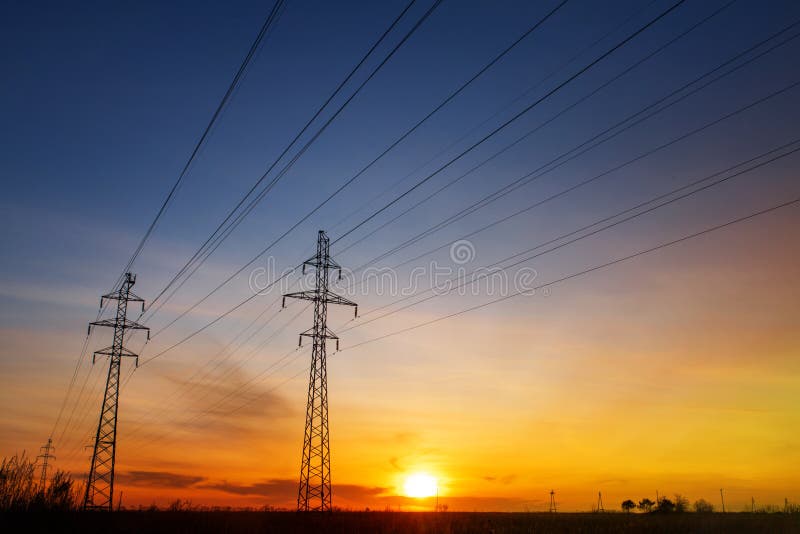 Power Lines at Sunset, Sun Rays. High Voltage Tower Against the Sky ...