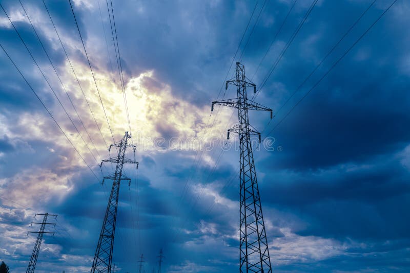Power Lines at Sunset, Sun Rays. High Voltage Tower Against the Sky ...