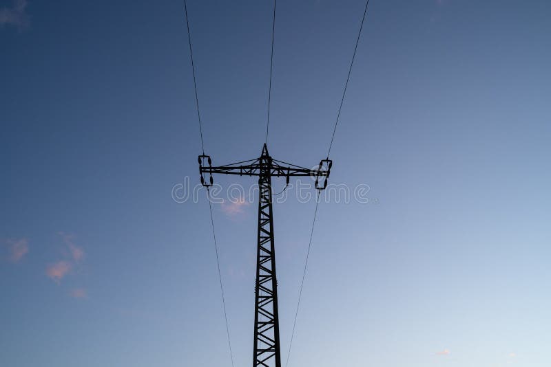 Power Pole with High Voltage Power Lines in the Blue Evening Sky Stock ...