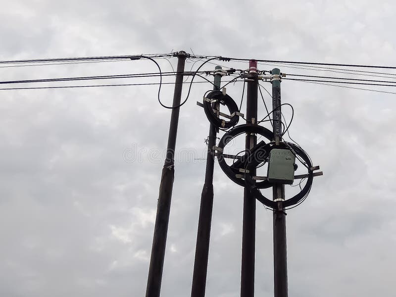 Power Poles with a Coiled Connecting Cable Stock Image - Image of poles ...