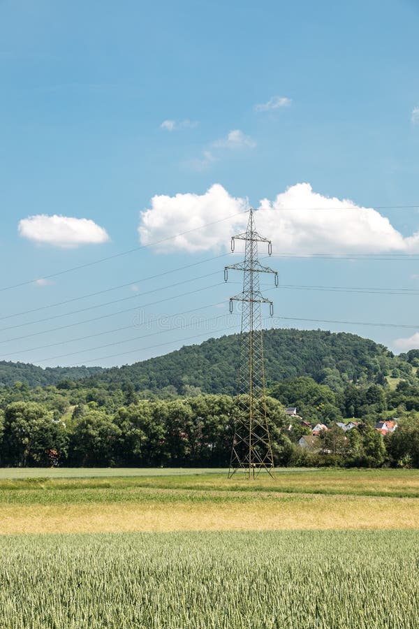Power Pylon in the German Countryside with Forests, Fields and M Stock ...
