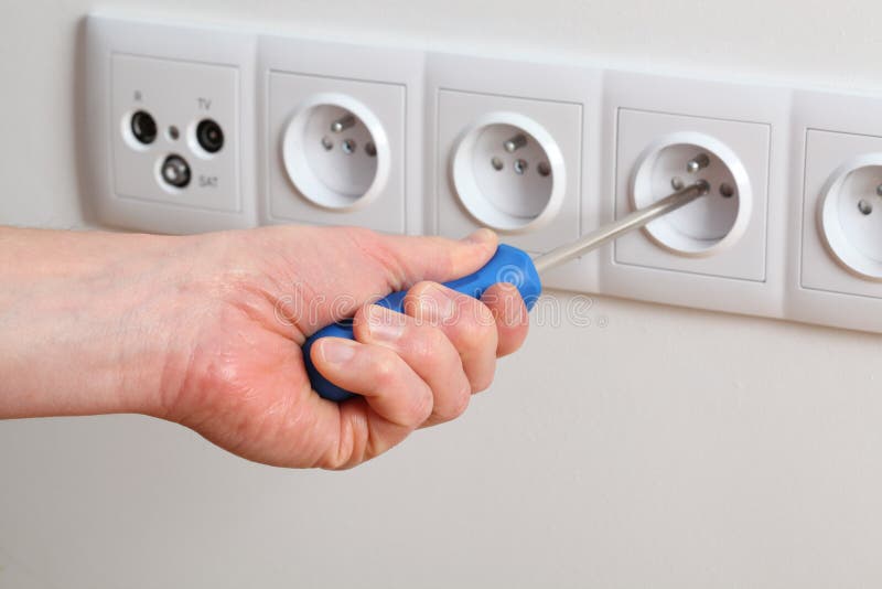 Pulling an Electrical Plug Out of a Wall Socket, Energy Saving Concept ...