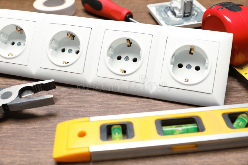 Power Socket and Set of Electrician`s Tools on Wooden Table, Closeup ...