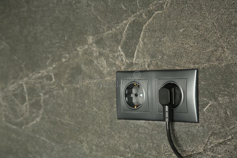 Power Sockets with Inserted Plug on Dark Grey Wall, Space for Text ...