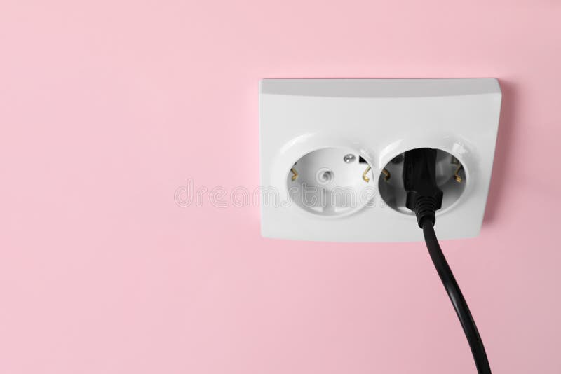 Power Sockets with Inserted Plug on Pink Wall, Space for Text ...