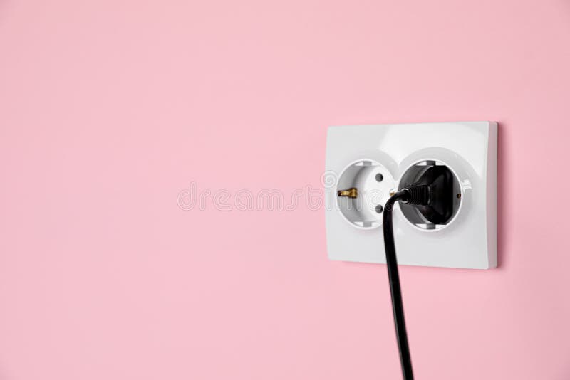 Power Sockets with Inserted Plug on Pink Wall, Space for Text ...
