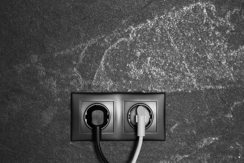 Power Sockets with Inserted Plugs on Dark Grey Wall, Space for Text ...