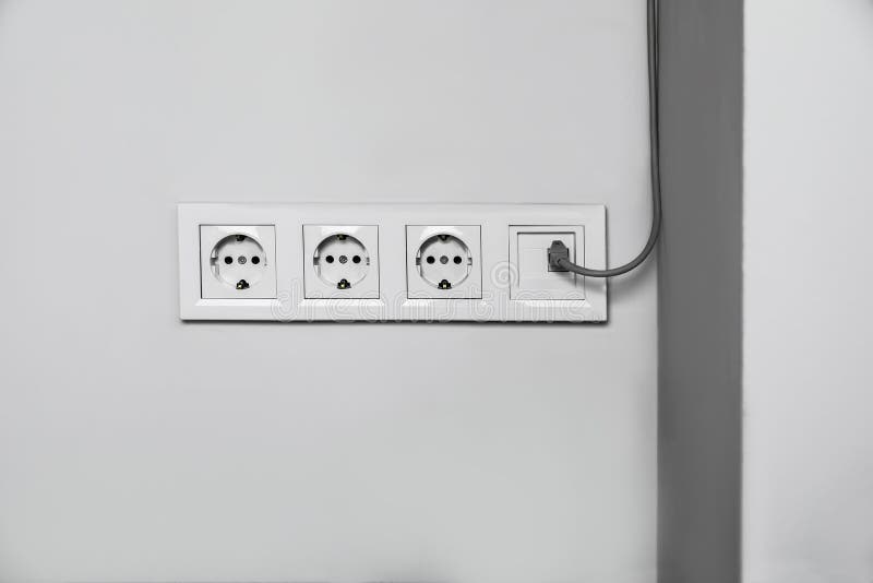Power Sockets with Internet Cable on White Wall. Electrical Supply ...