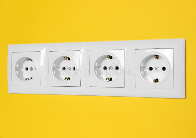 Power Sockets on Yellow Wall, Closeup. Electrical Supply Stock Image ...