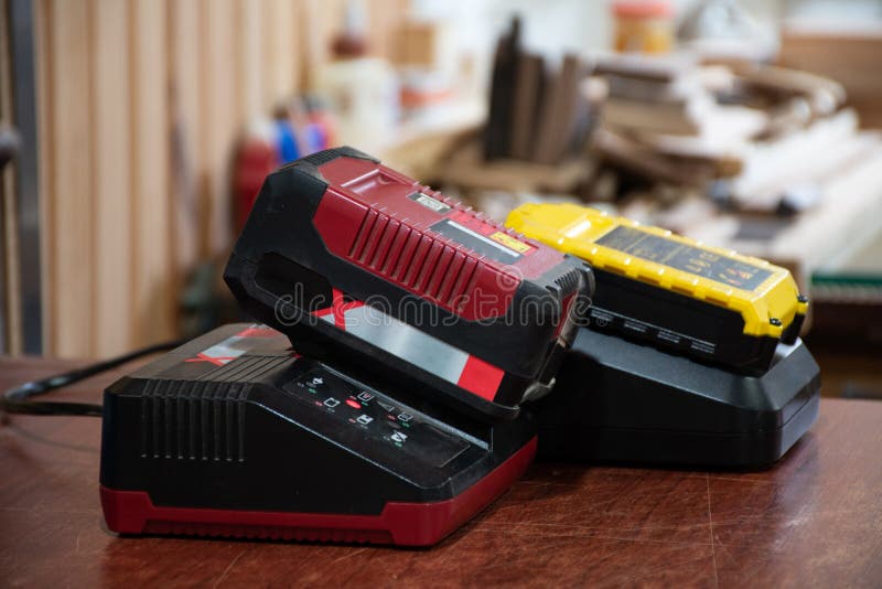 Power Tools Lithium-ion Batteries on Charge for Hand Tools on Workbench ...