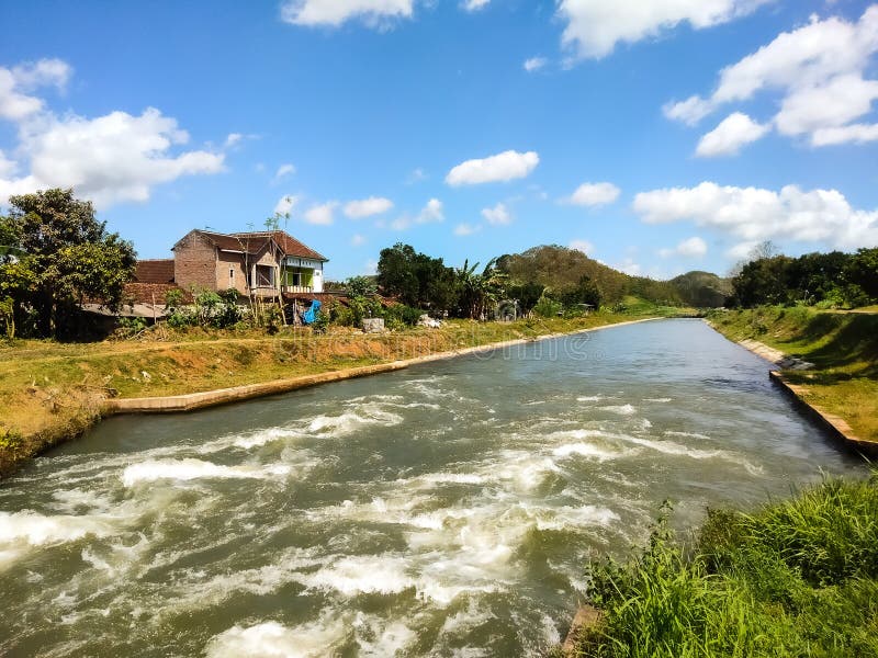 The Power of Water from Canal Flows Side the River Banks in Lodoyo ...