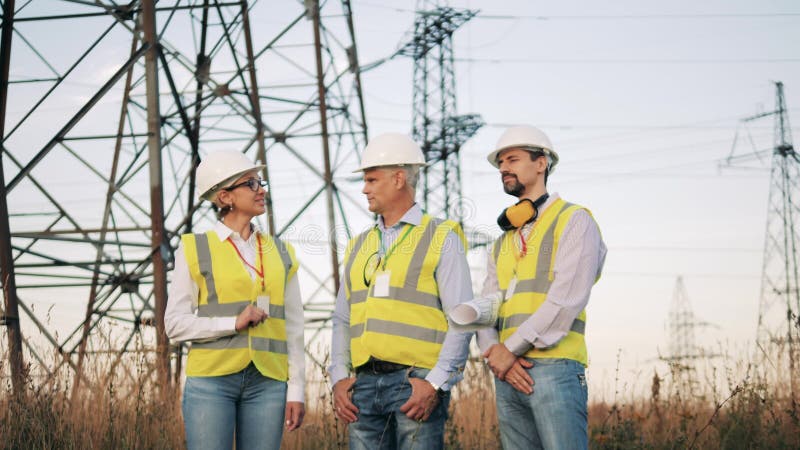 Power Workers are Talking about Plans in the Field with Electrical ...