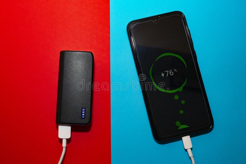 Powerbank Loading a Cell Phone on a Blue and Red Background Stock Photo ...