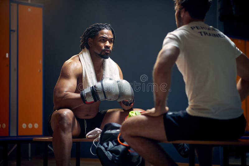 Powerful Boxer in Sweats Resting on Bench after Workout, Talking with ...