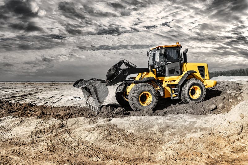 Powerful Bulldozer or Loader Moves the Earth at the Construction Site ...