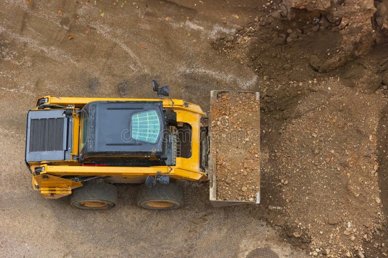 Powerful Bulldozer or Loader Moves the Earth at the Construction Site ...