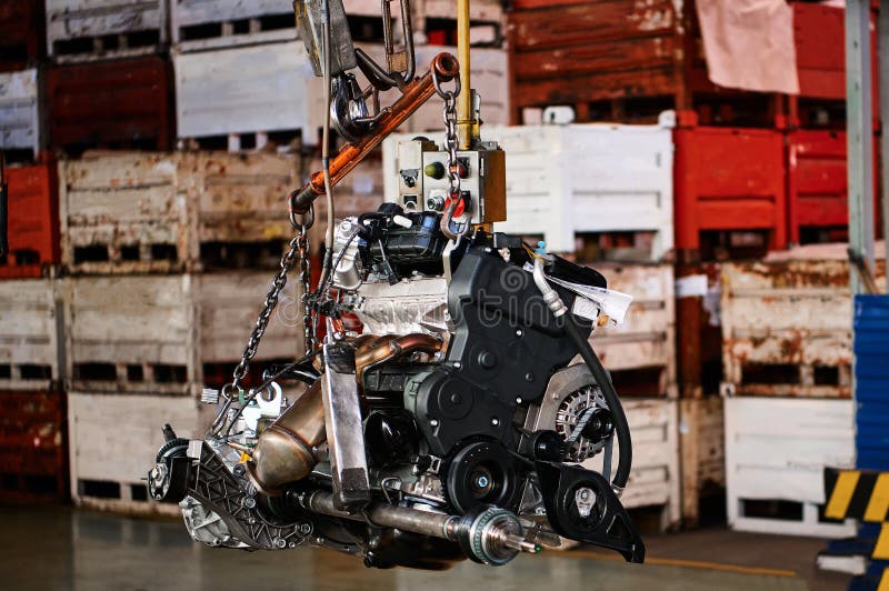 Powerful Car Motor Hangs on Chains in Assembling Workshop Stock Photo ...
