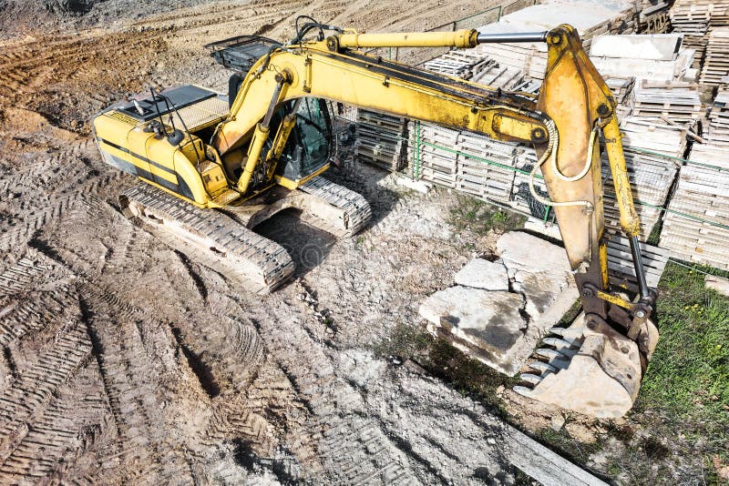 A Powerful Crawler Excavator is Working on a Construction Site. Close ...