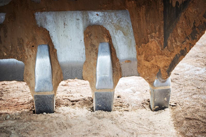 Heavy Machinery Digging into the Earth at a Construction Site during ...