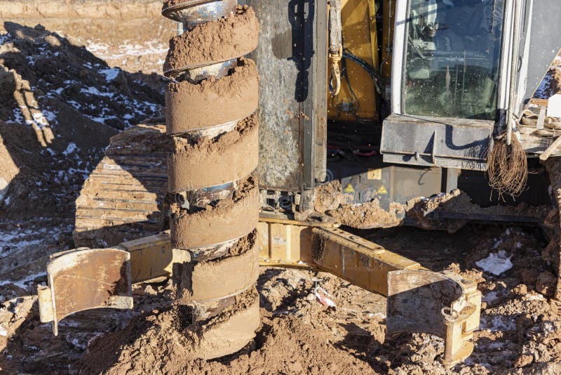 A Powerful Drilling Rig with an Auger Drills a Well at a Construction ...