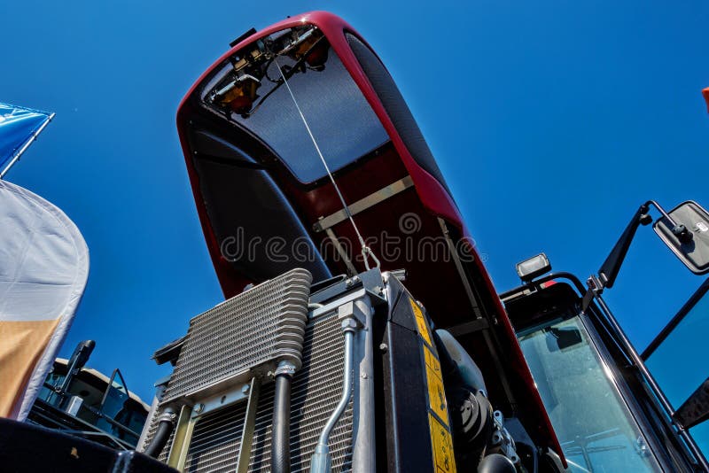 The Powerful Front End of a Modern Tractor Under a Brilliant Blue Sky ...