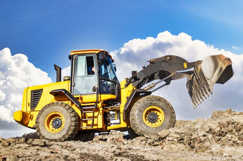 Powerful Front Wheel Loader or Bulldozer Working on a Quarry or ...