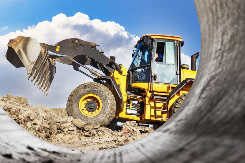 Powerful Front Wheel Loader or Bulldozer Working on a Quarry or ...