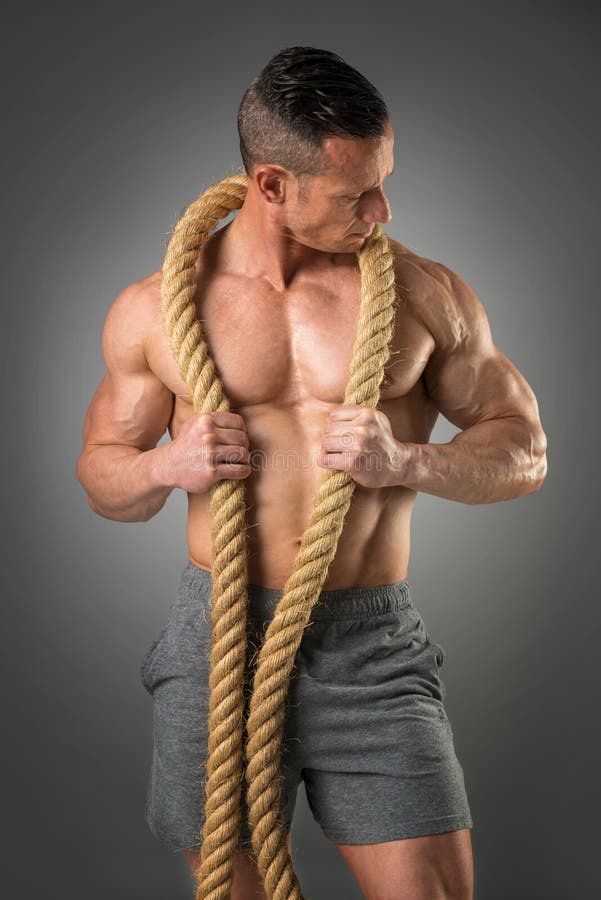 Powerful man with a rope stock image. Image of sportsman - 112253931