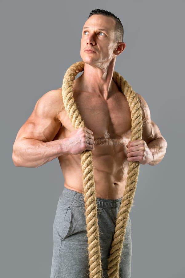 Powerful man with a rope stock image. Image of exercise - 86430503