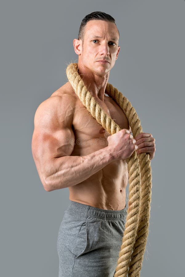 Powerful man with a rope stock photo. Image of perfect - 90659038