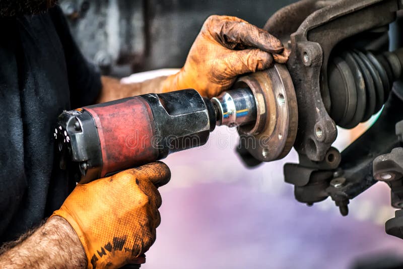 Powerful Mechanic Hand Drilling on a Car Wheel Stock Photo - Image of ...