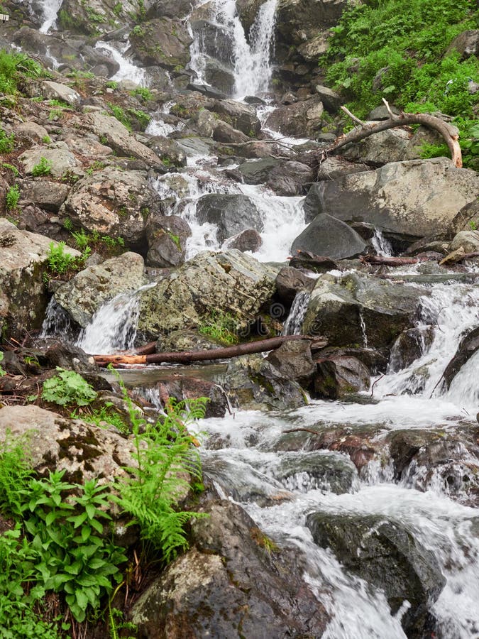 A Powerful Mountain Stream Flows Down from the Rocks and Stones Stock ...