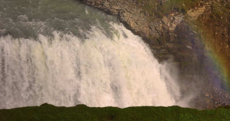 A Powerful Stream of Water from a Natural Waterfall with a Rainbow in ...