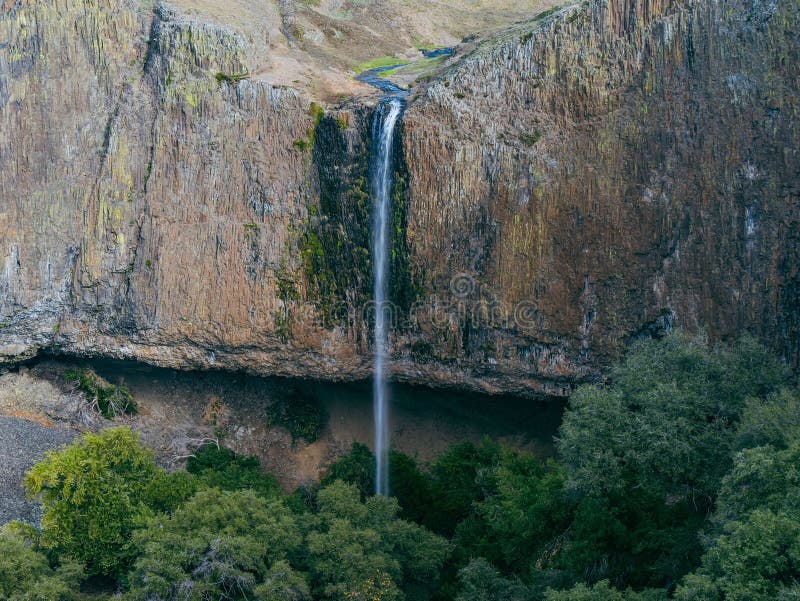 Powerful Waterfall Cascades Down the Side of a Towering Mountain. Stock ...