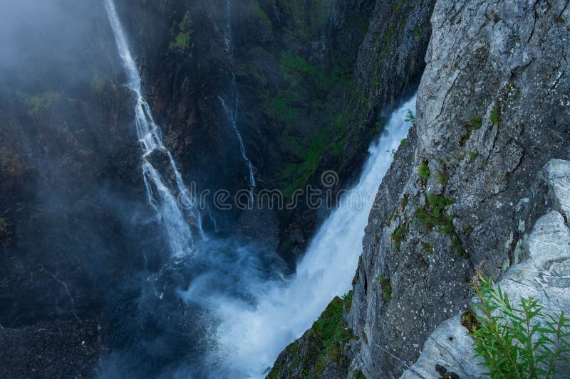 A Powerful Waterfall Cascading Down a Rugged Cliff Stock Image - Image ...