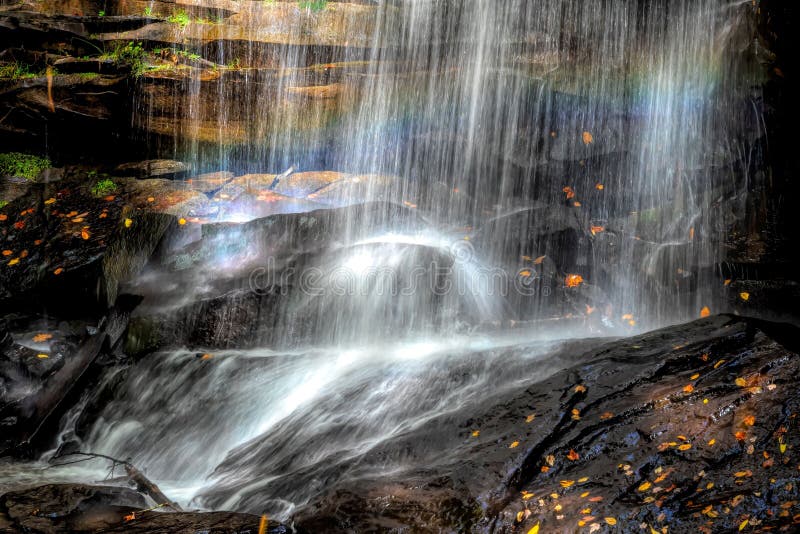 Powerful Waterfall Falling on the Rocks of a Lake with a Visible ...